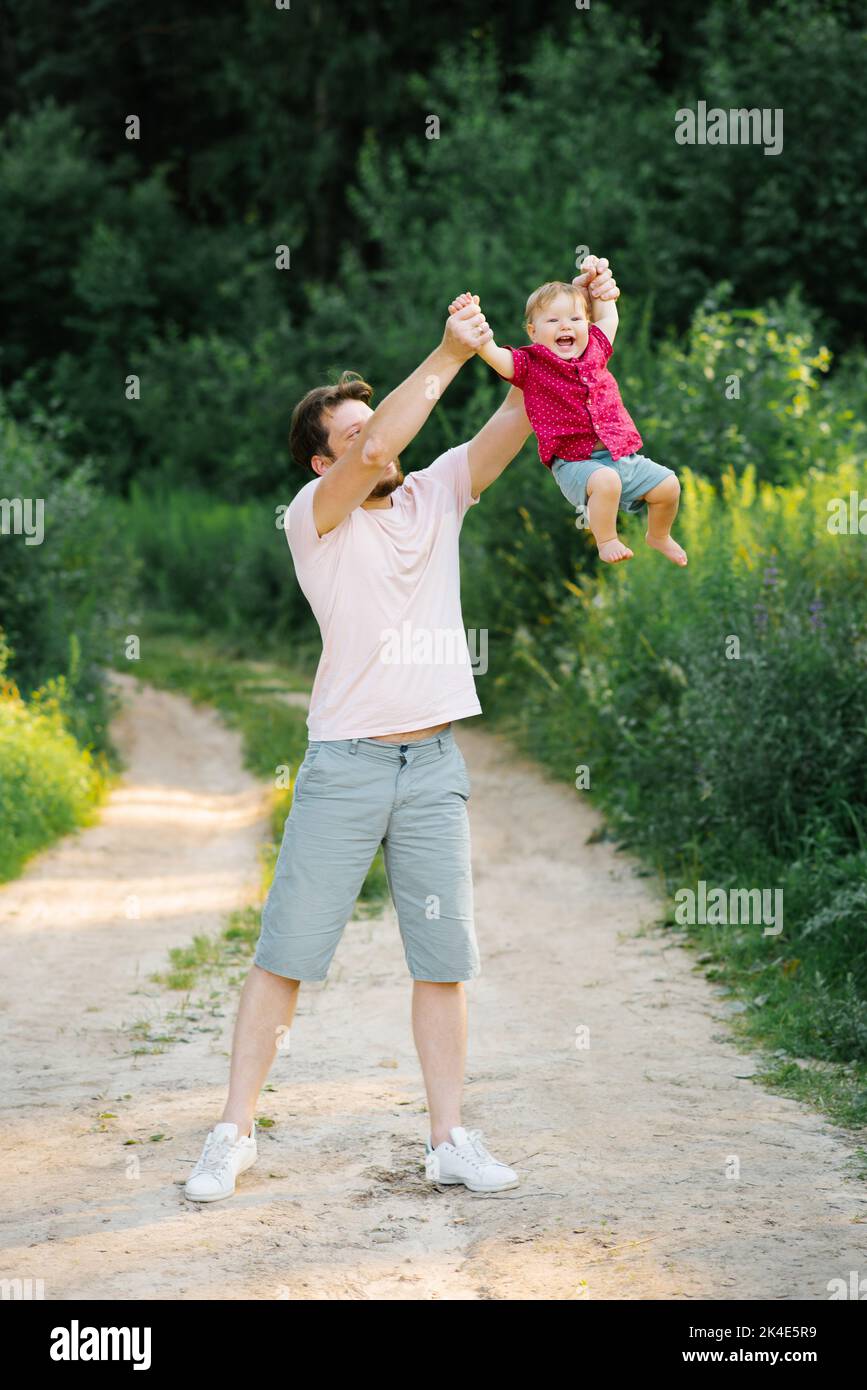 Happy dad having fun with his little son, tossing him up Stock Photo ...