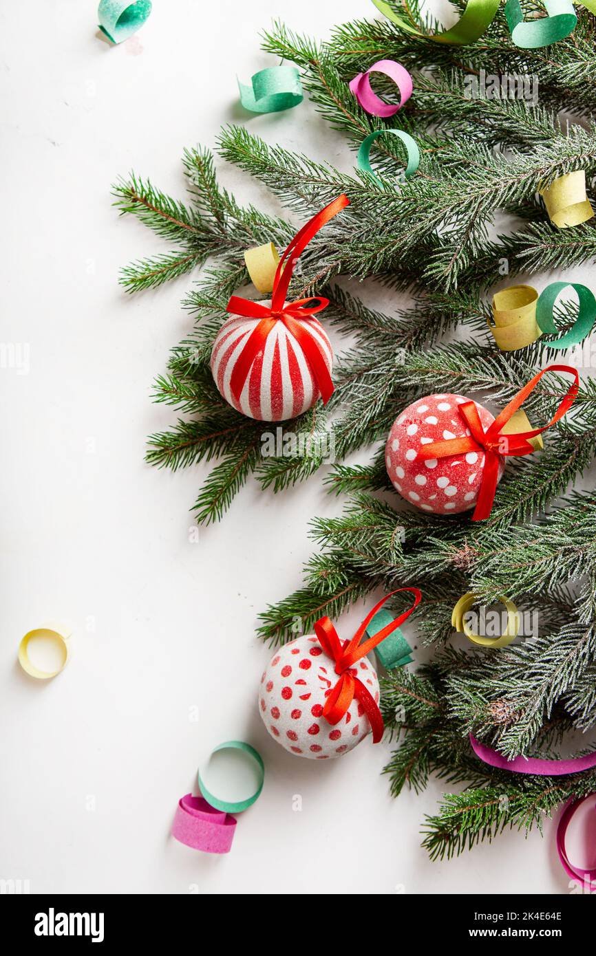 Christmas tree green branches and decorations on light surface holiday ...