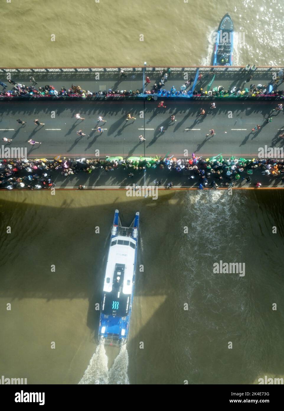 Runners cross Tower Bridge during the TCS London Marathon. Picture date ...