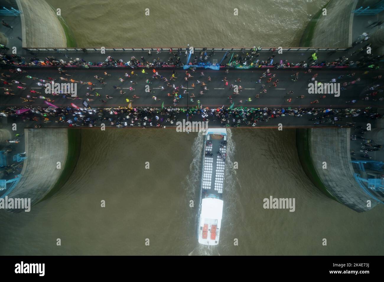 Runners cross Tower Bridge during the TCS London Marathon. Picture date ...