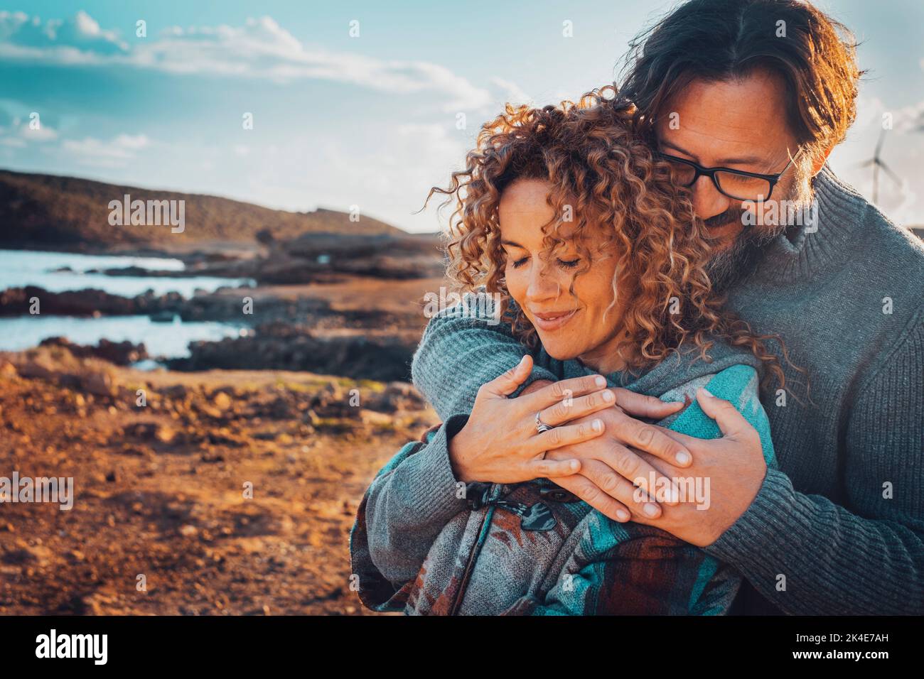 Happy young couple in love hugging outdoors with tenderness and ...