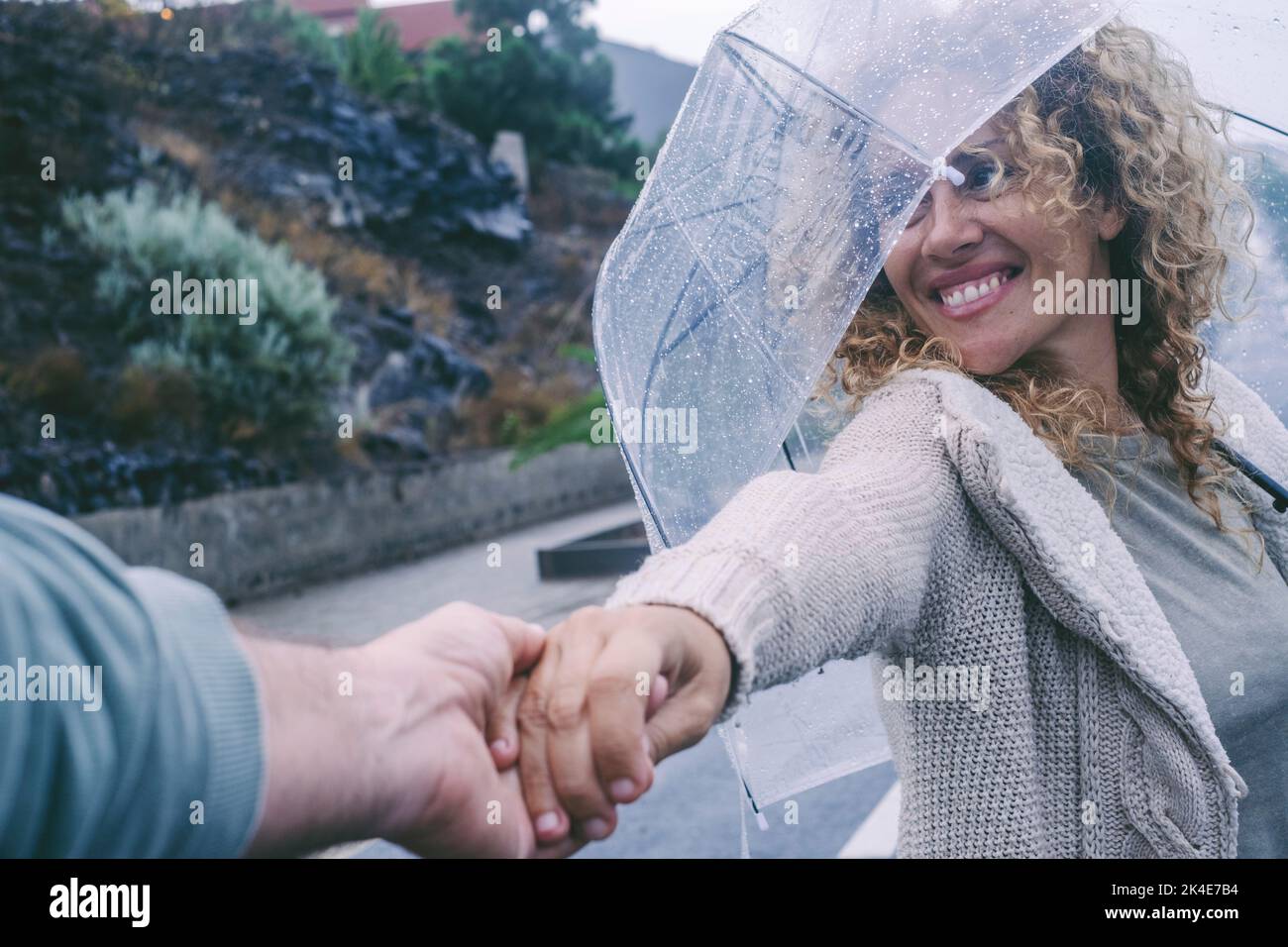 Boy And Girl Holding Hands In Rain
