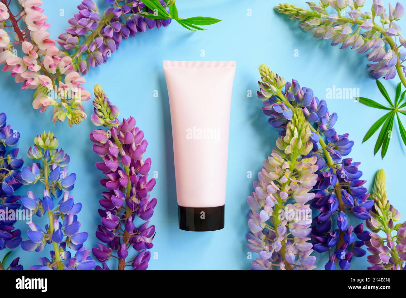 Pink squeeze bottle cosmetic tube with screw black cap and multicolored ...