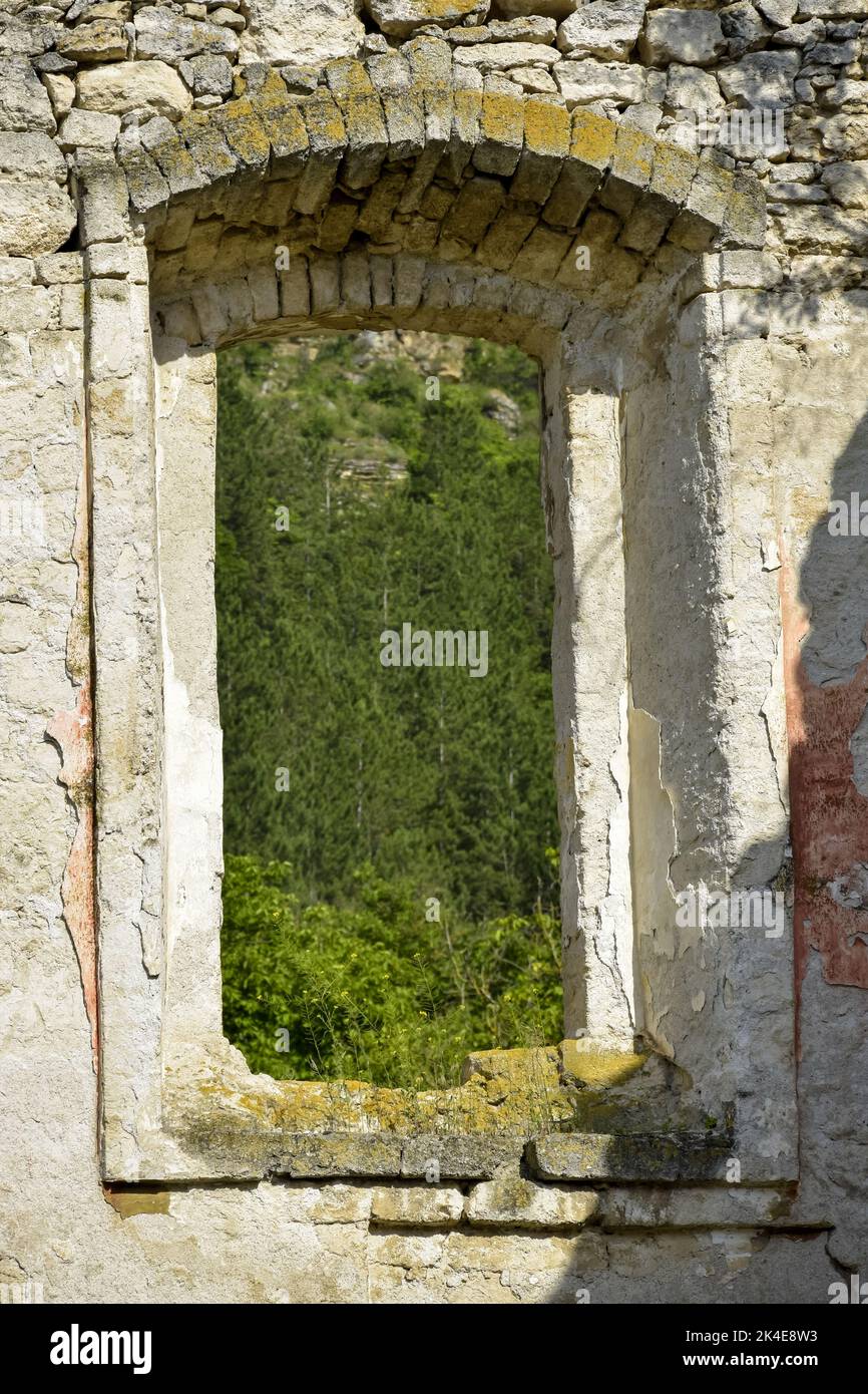 Picturesque view through window of old ruined building. Ruins of ...