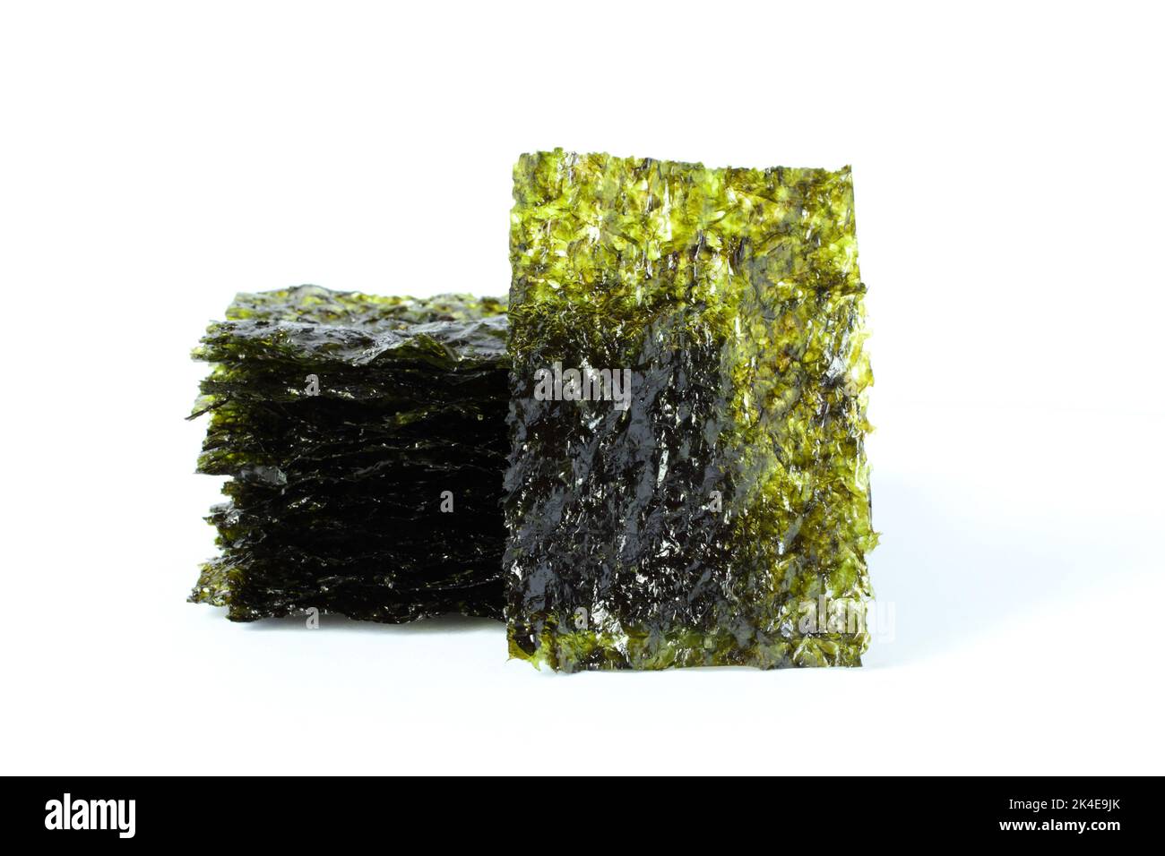 Seasoned seaweed snack. Algae sheets stacked in a pile on white ...