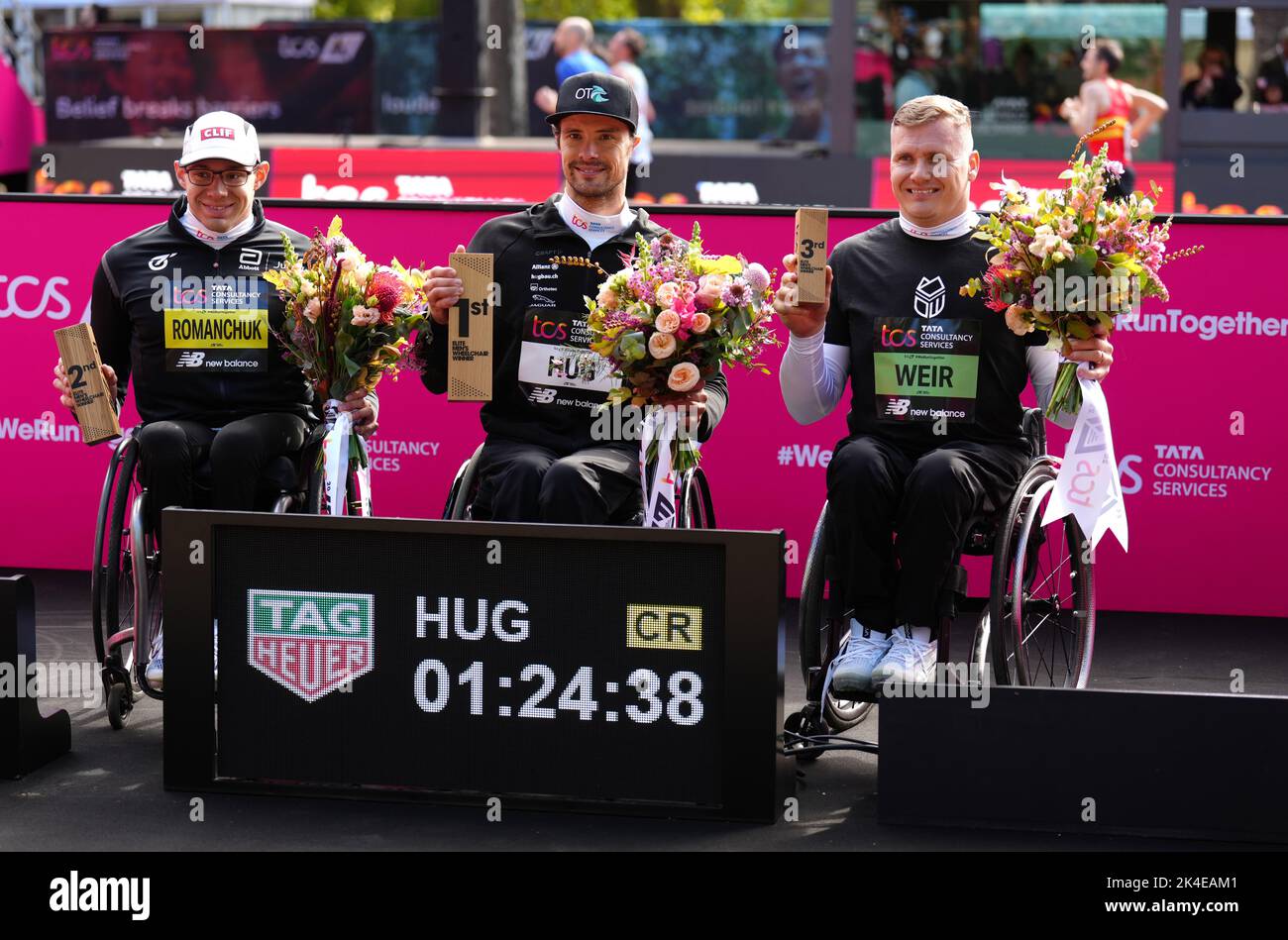 Switzerland's Marcel Hug (centre) poses after winning the Men's Elite ...