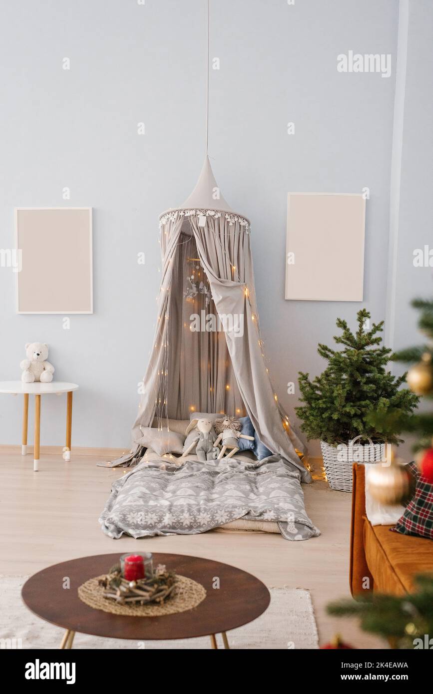 Christmas kids room: bed with fabric awning, toys and pillows ...