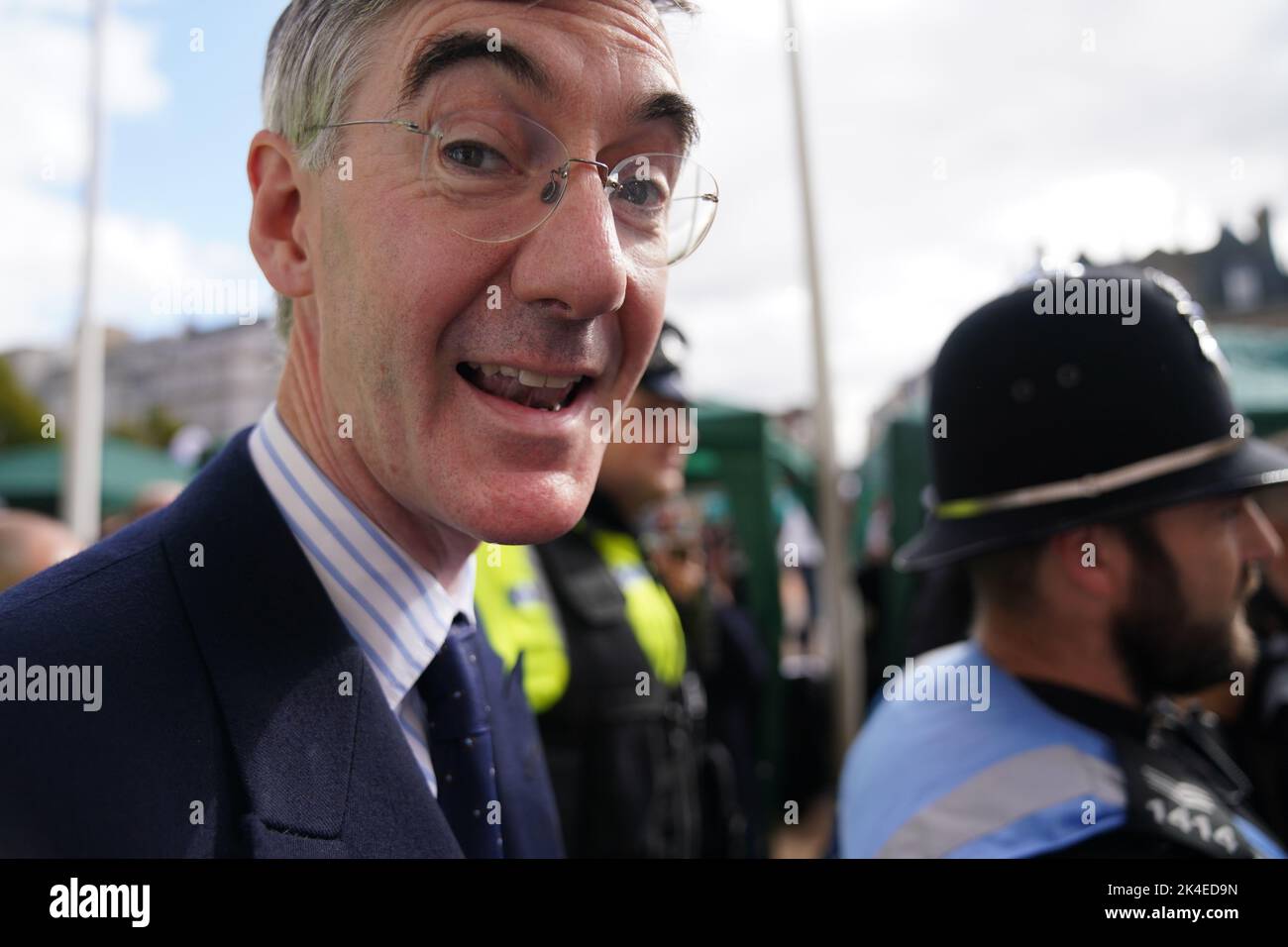 Business Secretary Jacob Rees-Mog is escorted by police officers at the ...