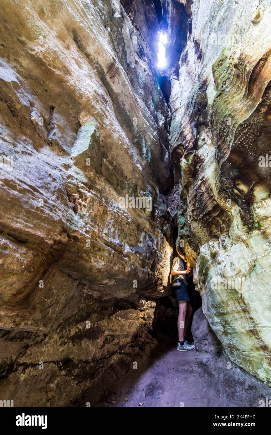 Waldbillig: hiker in narrow passage between the rocks Rittergang in ...