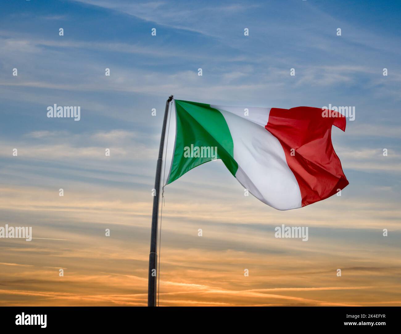 Italian flag waving on sunset sky Stock Photo - Alamy