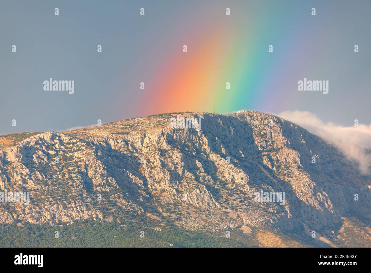 Rainbow over the mountain peak . Spectacular natural phenomenon Stock ...