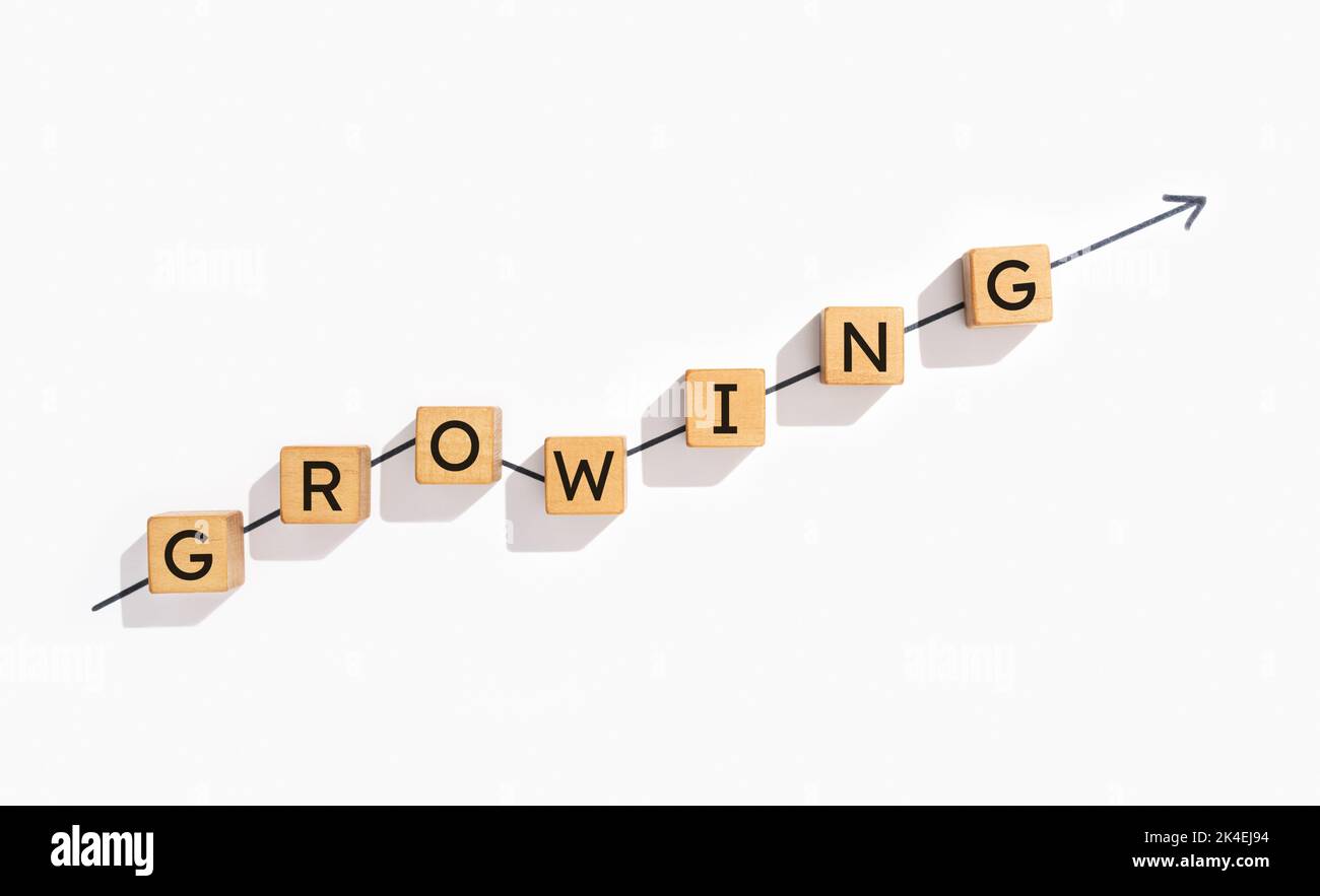 Growing word on wooden blocks on growth chart. Copy space Stock Photo ...