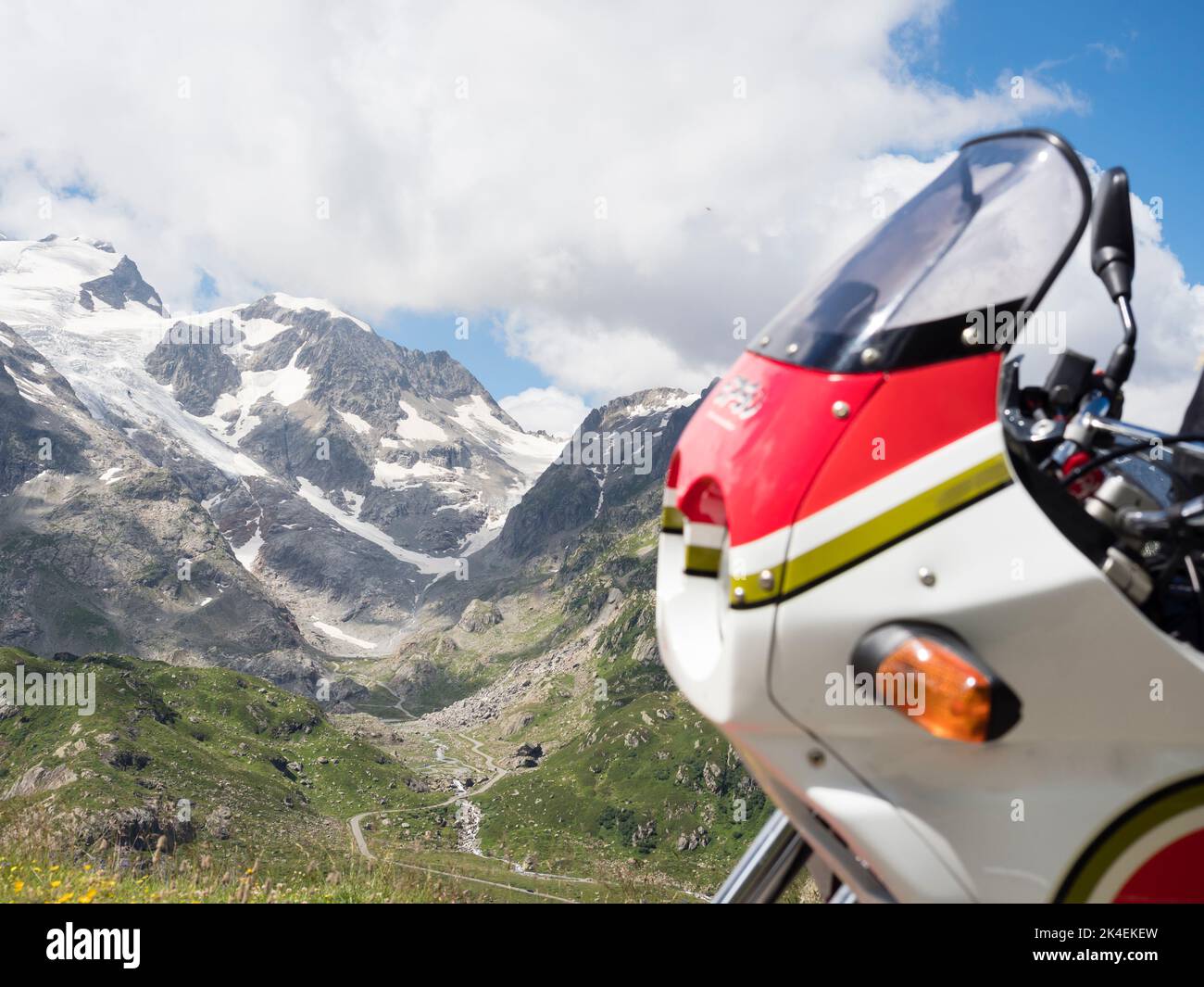 Front of an adventure motorcycle at a mountain pass in the Swiss alps ...