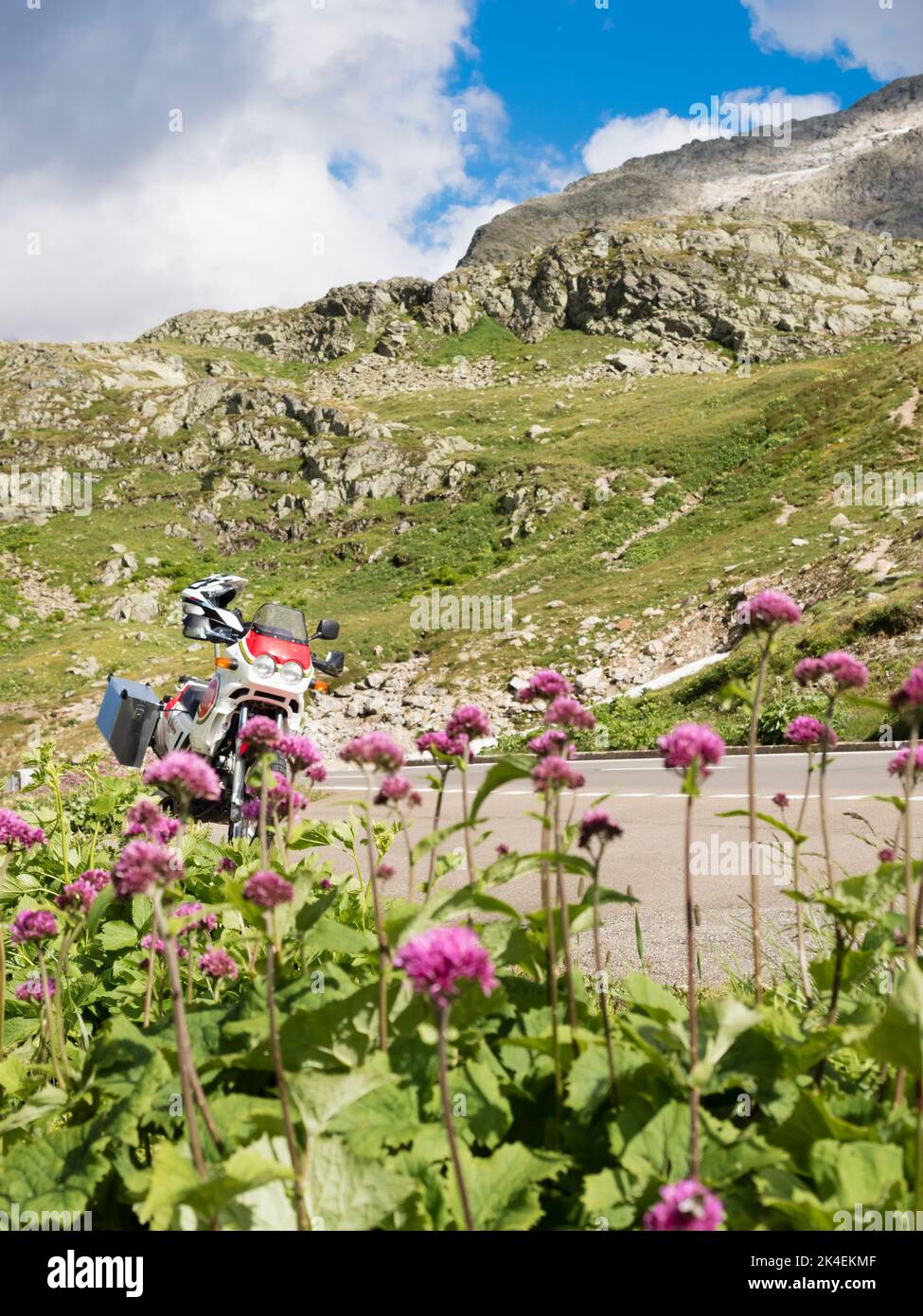 Front view of an adventure motorcycle at a mountain pass in the Swiss ...