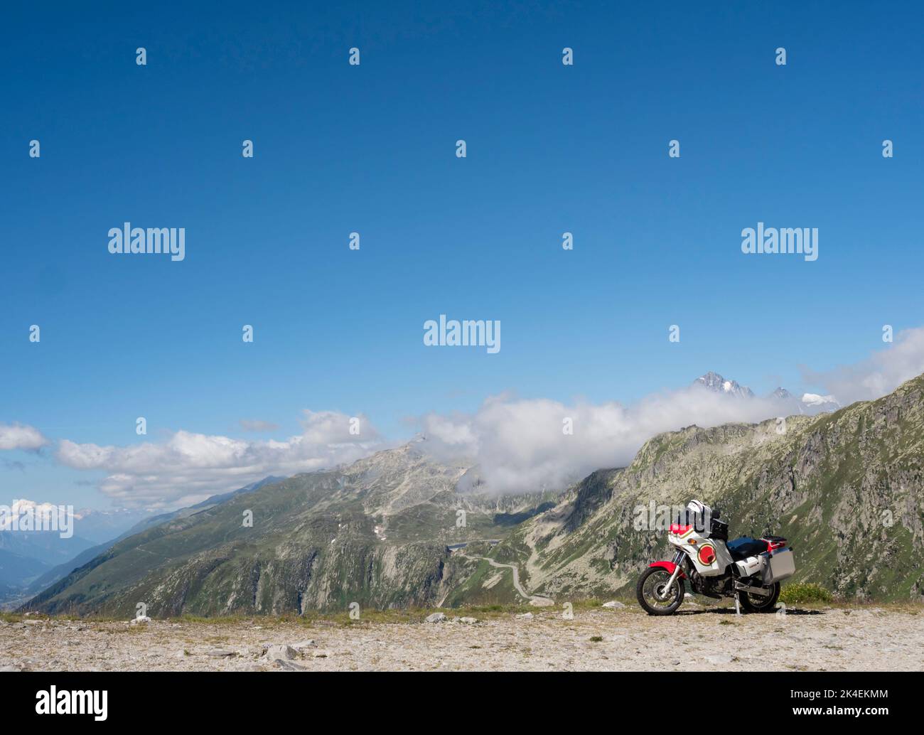 An adventure motorcycle with is parked at a mountain pass in the Swiss ...