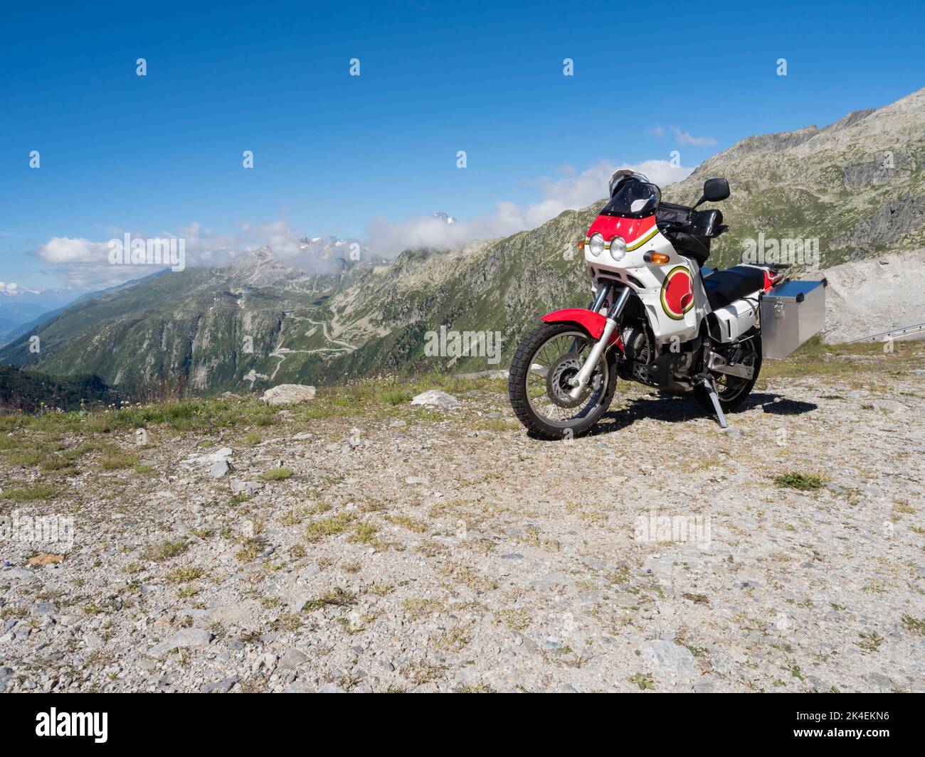 An adventure motorcycle with is parked at a mountain pass in the Swiss ...