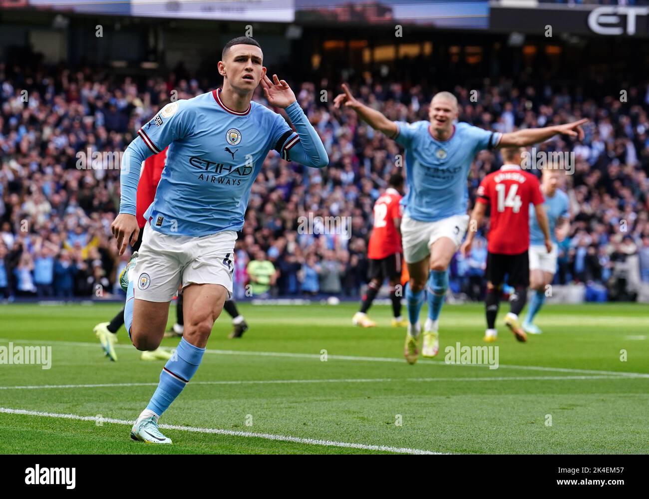 Manchester City's Phil Foden (left) celebrates scoring their side's ...