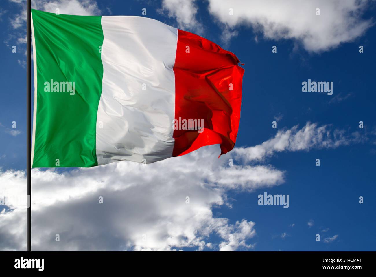 Italian flag waving on blue sky with white clouds Stock Photo - Alamy