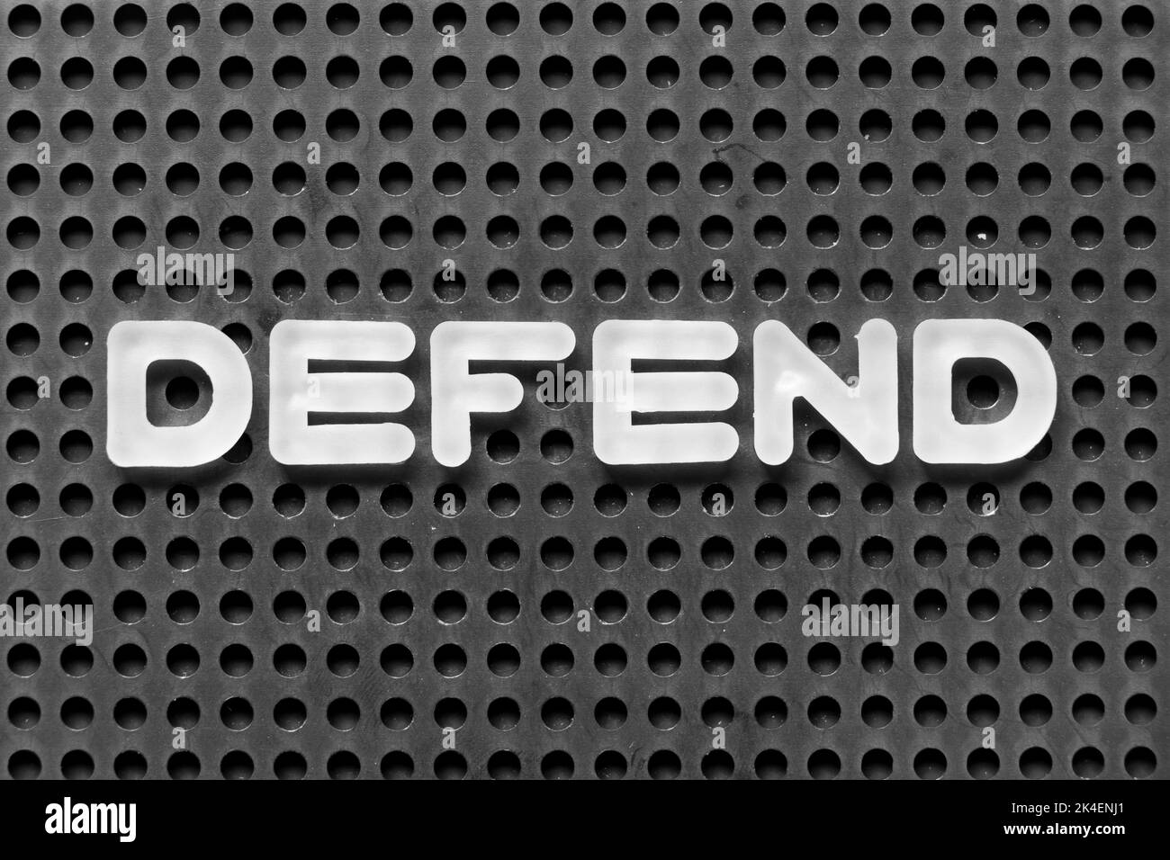 White alphabet letter in word defend on black pegboard background Stock ...