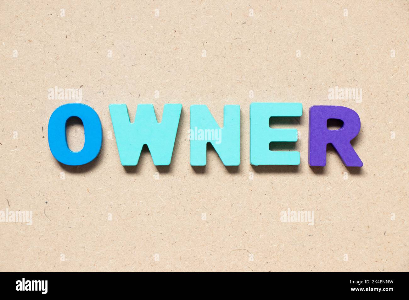 Color alphabet letter in word owner on wood background Stock Photo - Alamy