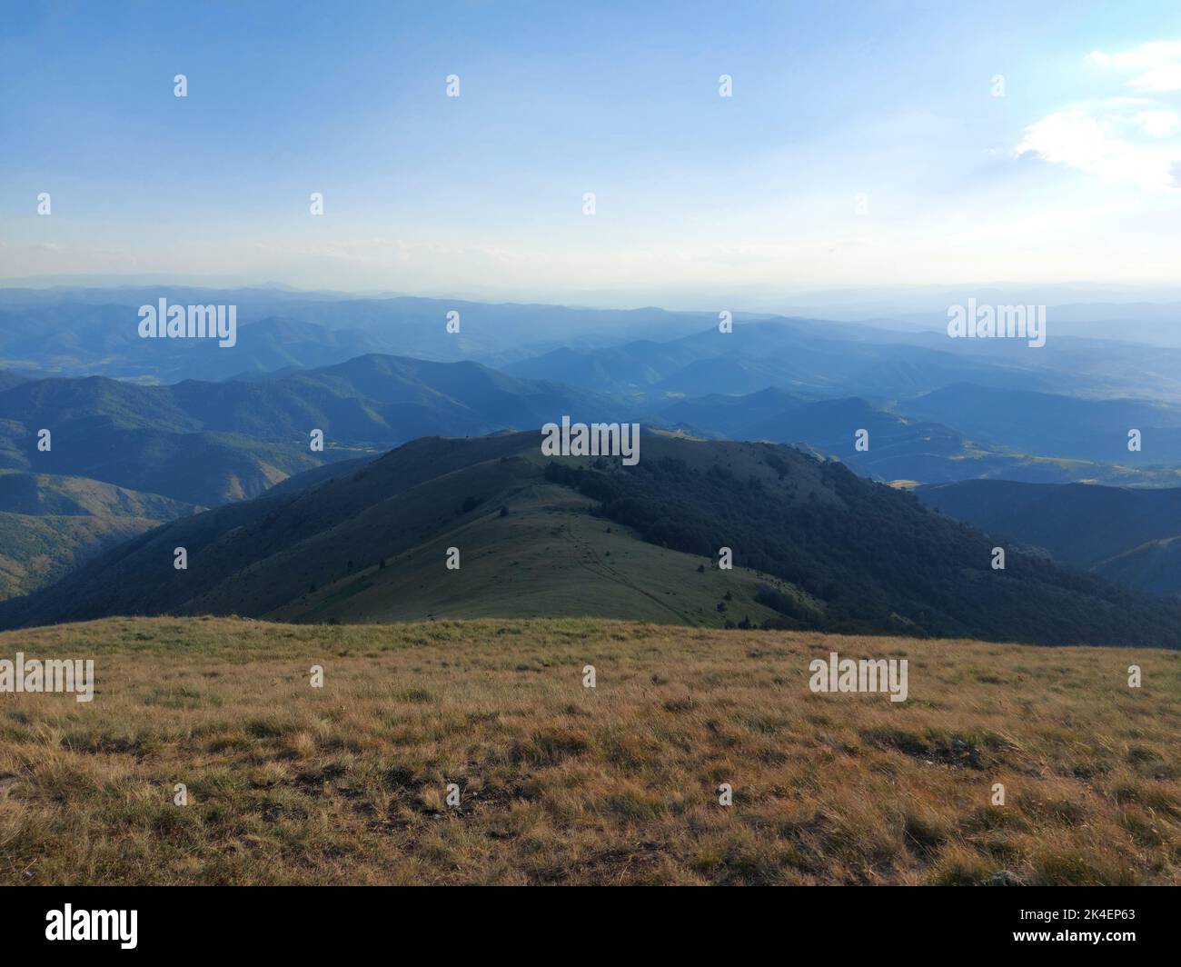 An aerial view of hills under a misty blue sky Stock Photo - Alamy