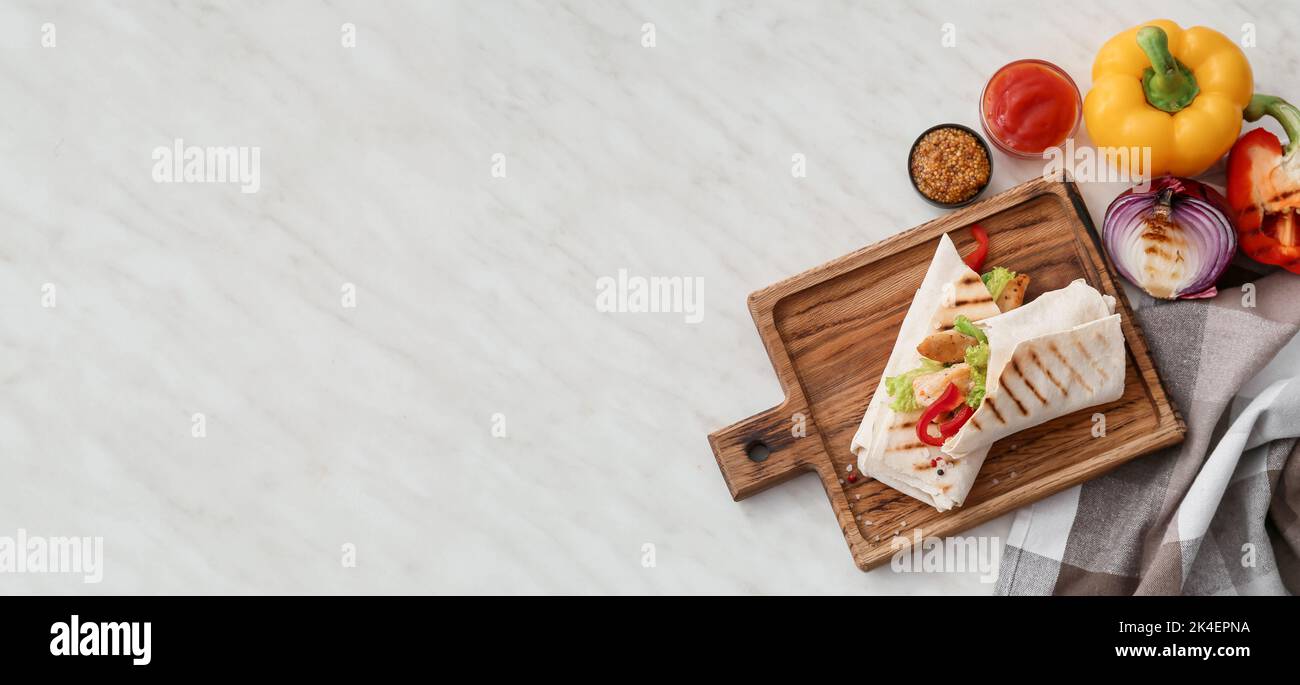Tasty doner kebab and ingredients on light background with space for ...