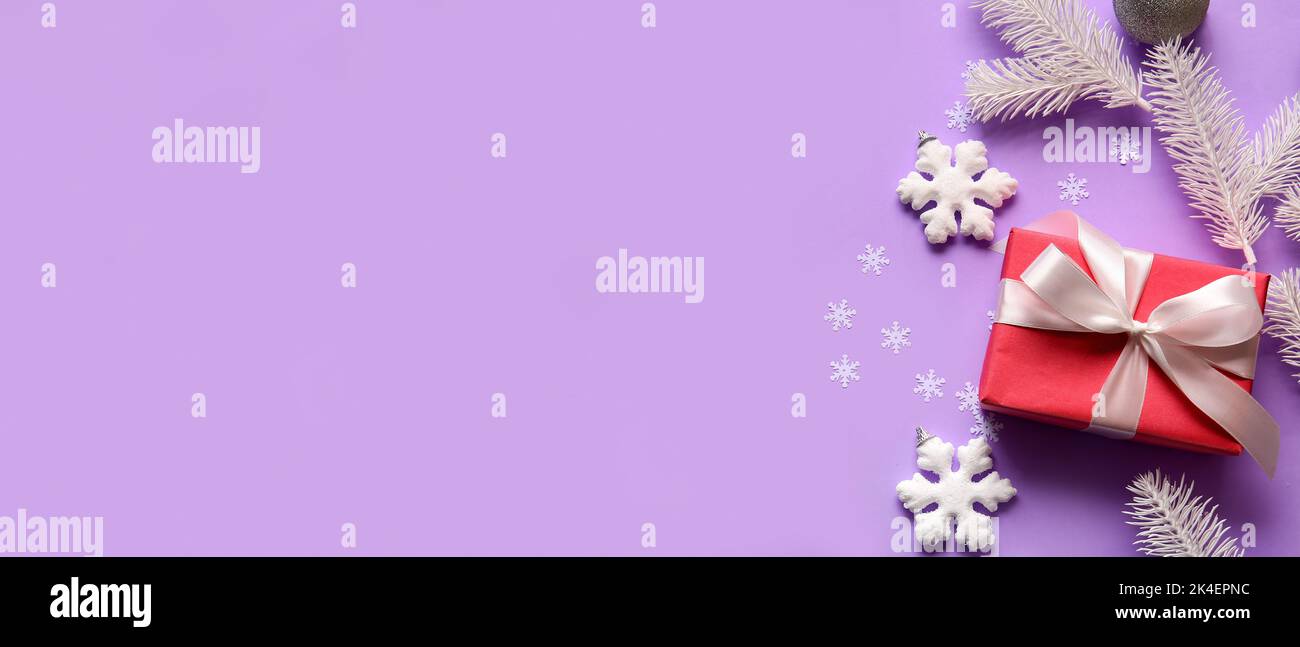 Beautiful Christmas composition with fir branches and gift box on lilac ...