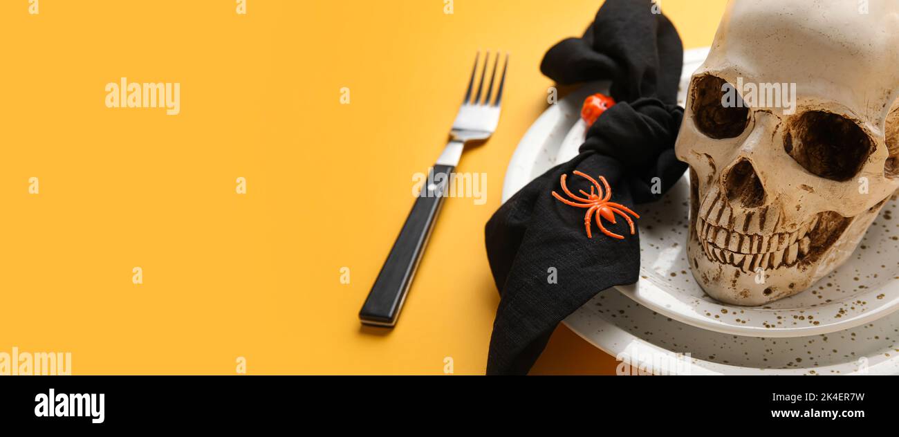 Halloween table setting with skull on orange background. Banner for ...