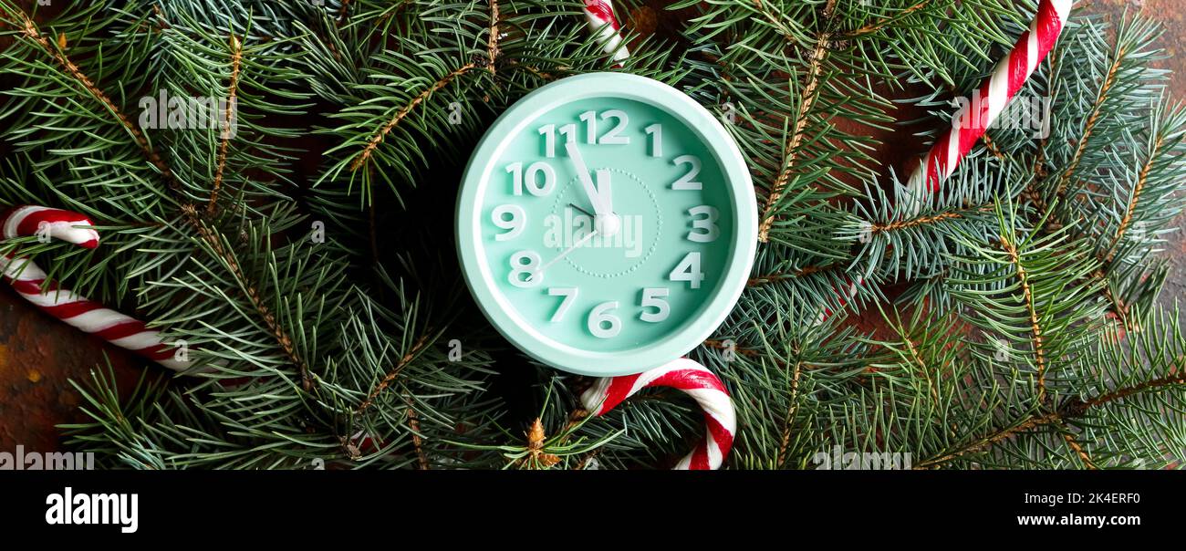 Alarm clock with fir branches and candy canes, top view. Christmas ...