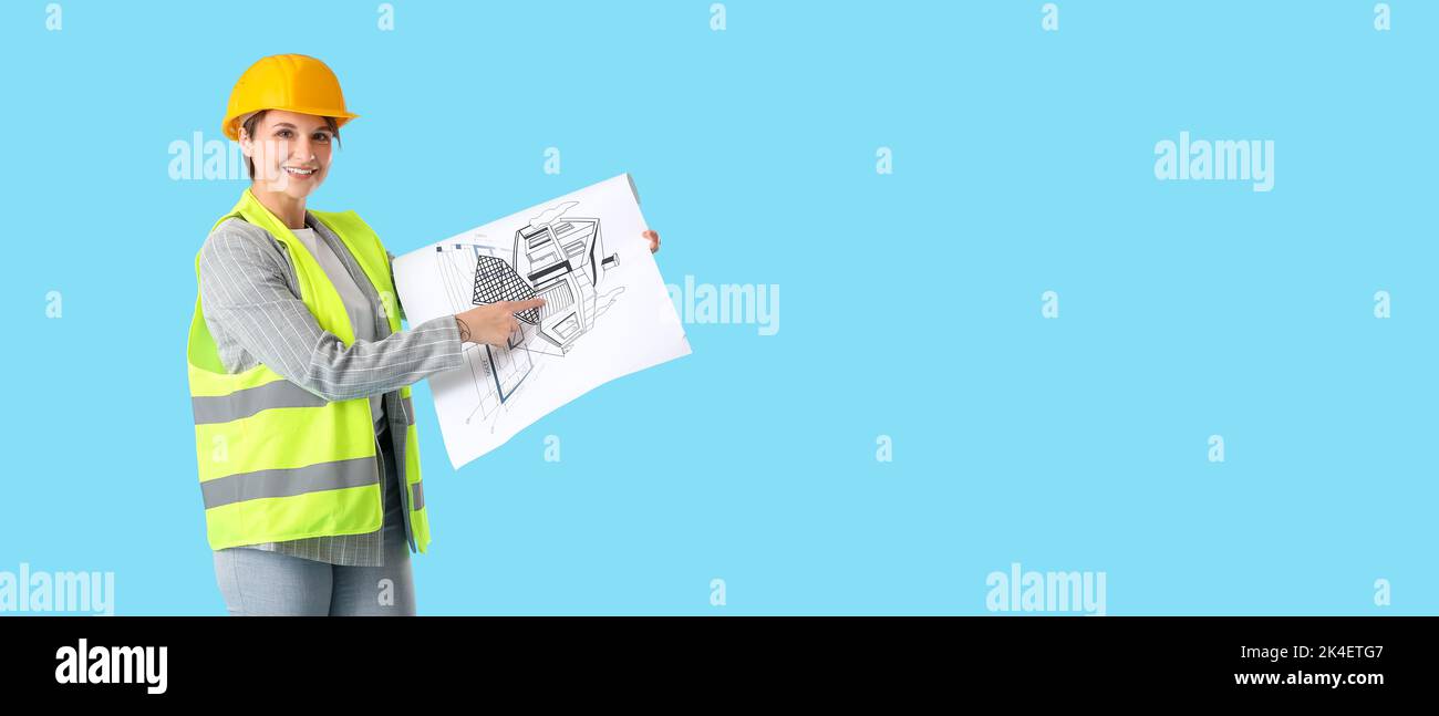 Female architect with plan of house on light blue background with space ...