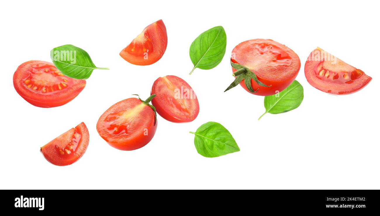 Fresh flying tomatoes and basil isolated on white Stock Photo - Alamy
