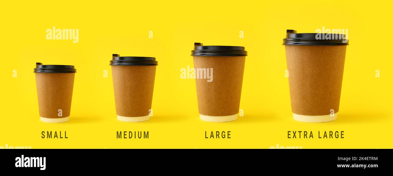 Different sized takeaway coffee cups on yellow background Stock Photo ...