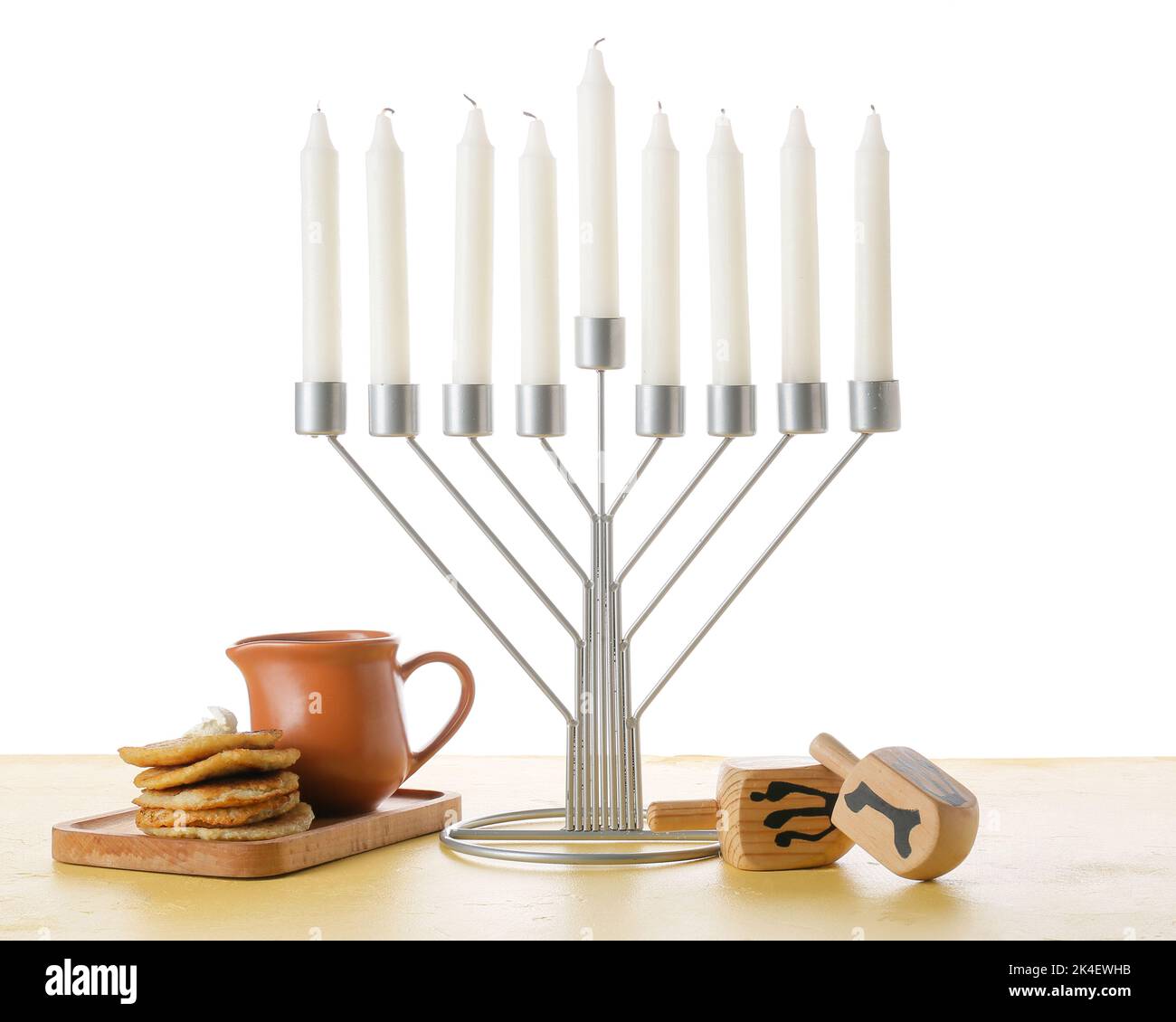 Menorah with candles, dreidels and potato pancakes for Hanukkah ...