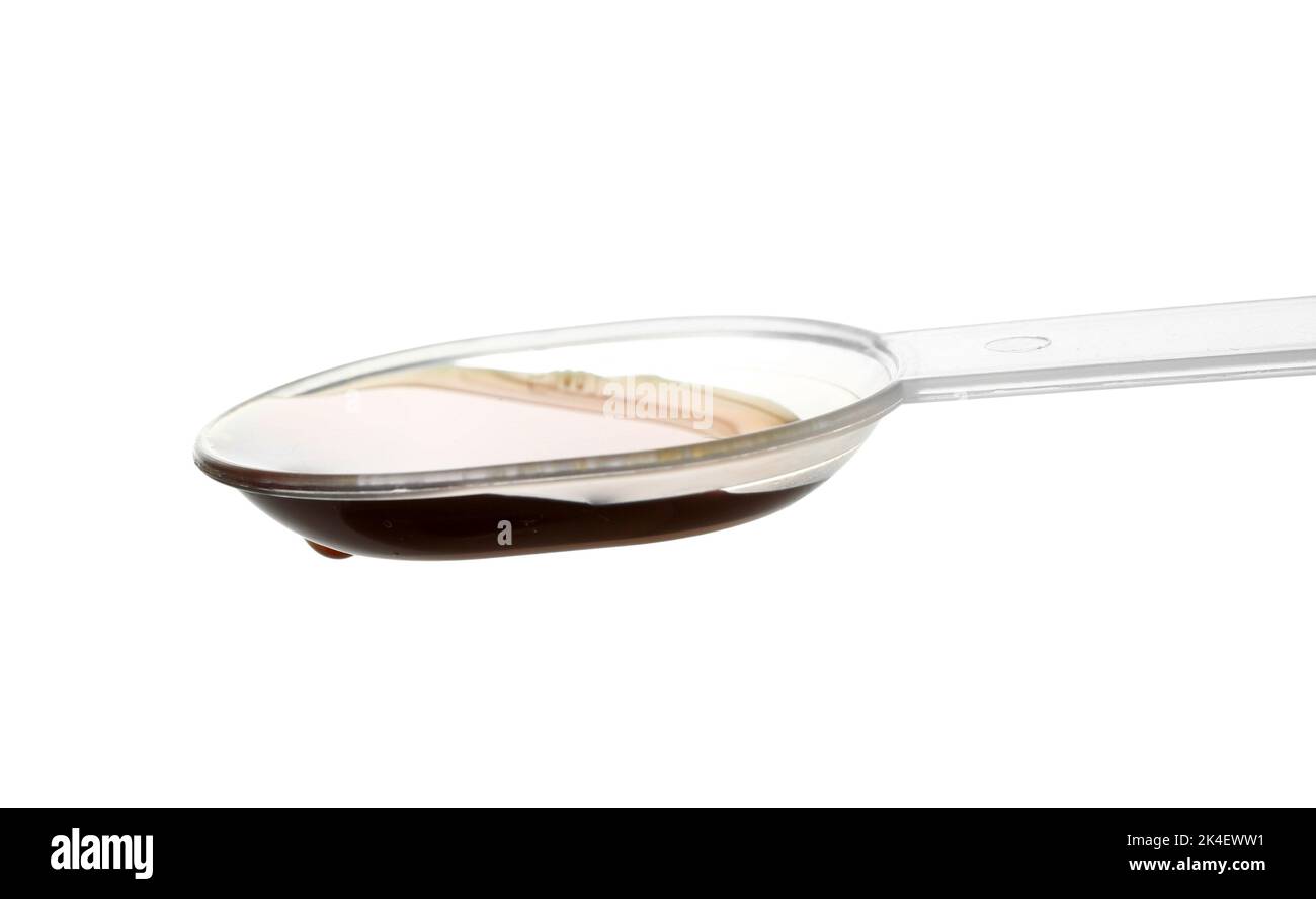 Spoon of cough syrup on white background Stock Photo - Alamy
