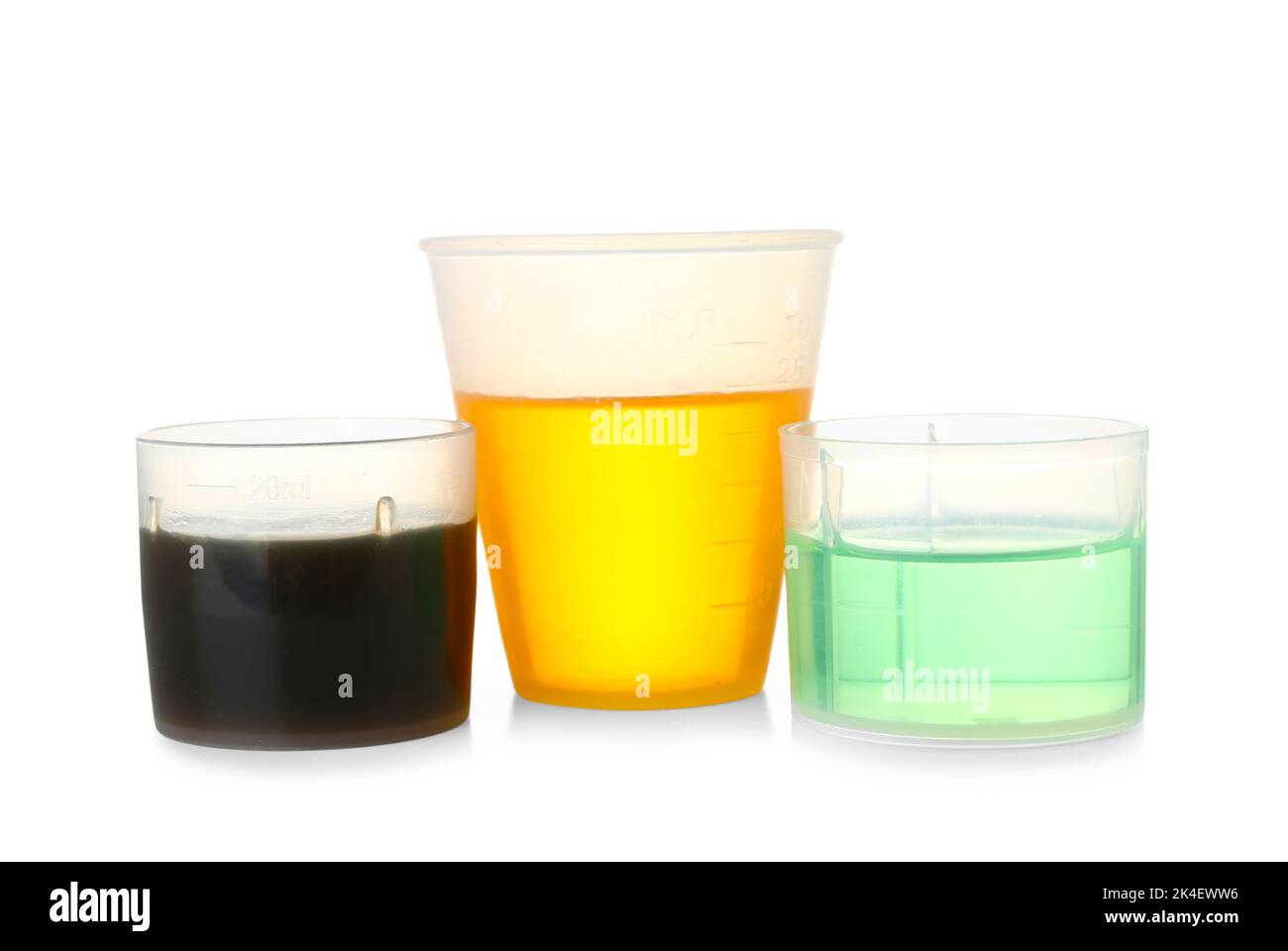 Measuring cups of cough syrup on white background Stock Photo - Alamy