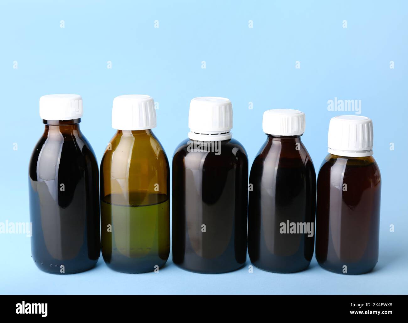 Bottles of cough syrup on blue background Stock Photo - Alamy