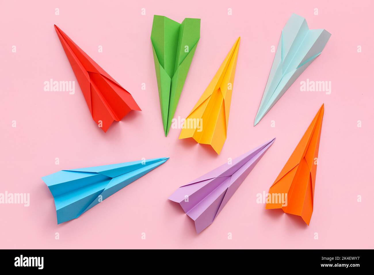 Colorful paper planes on pink background Stock Photo - Alamy