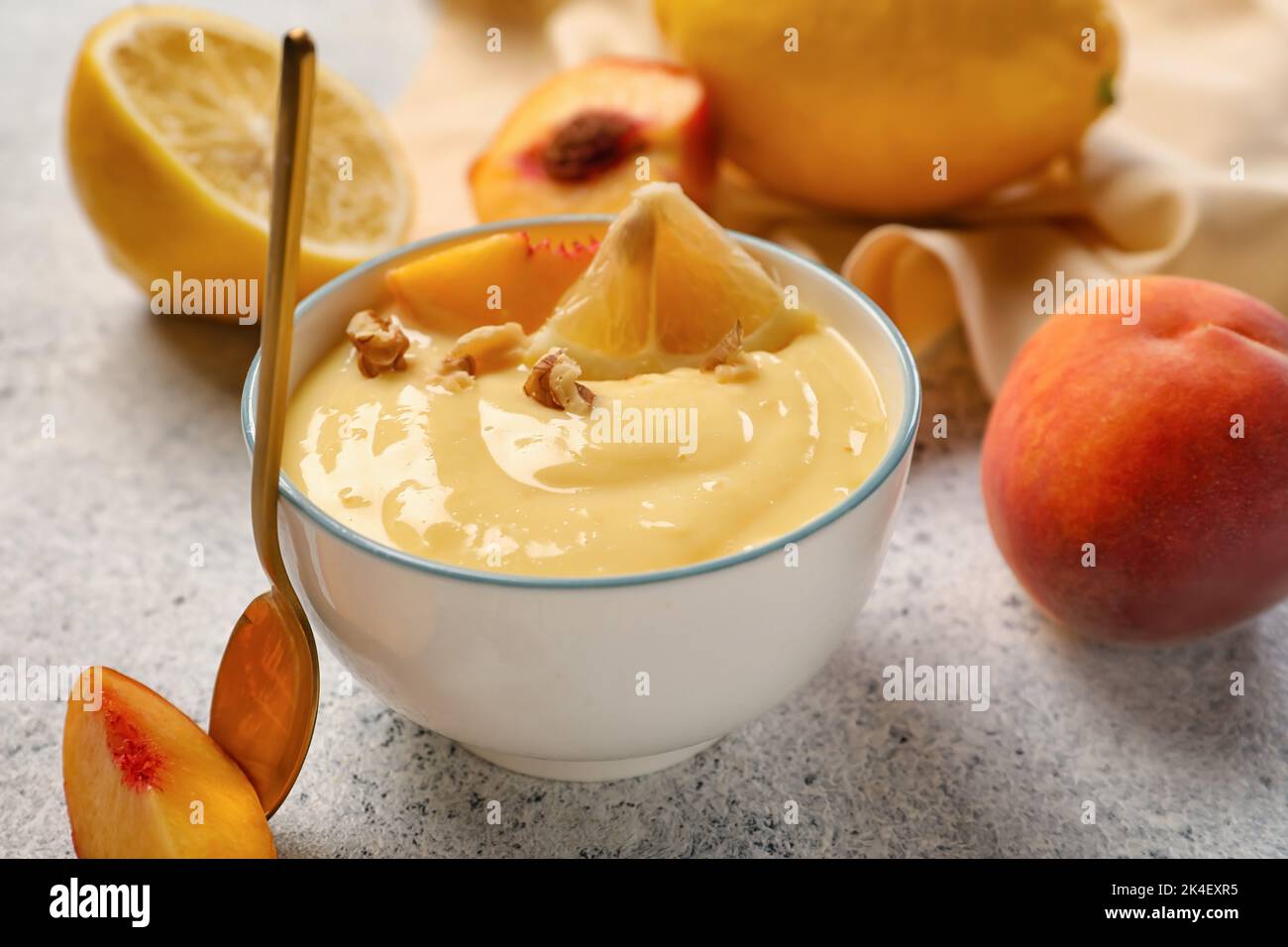 Bowl of delicious vanilla pudding with fruits on light background ...