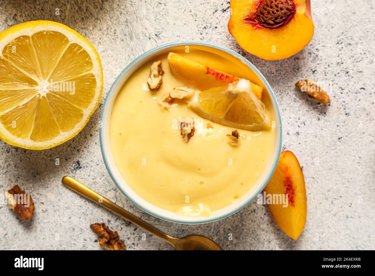 Bowl of delicious vanilla pudding with fruits on light background ...