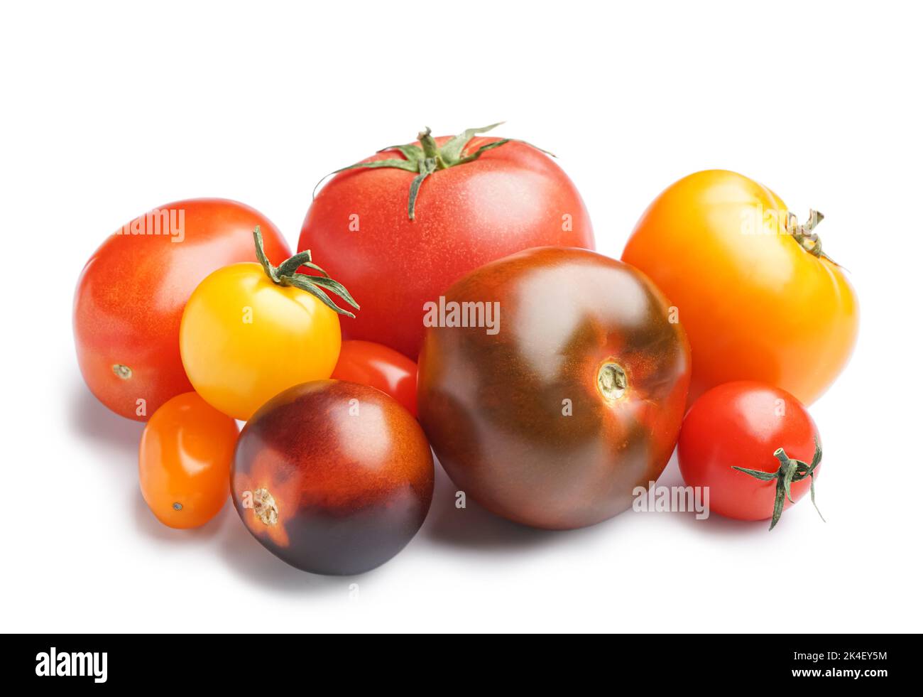 Heap of different tomatoes on white background Stock Photo - Alamy