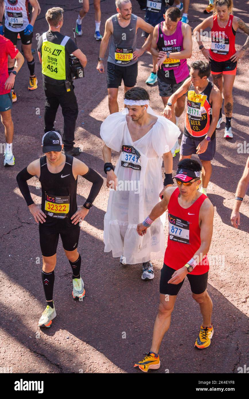London UK. 2 October 2022 . A marathon runner in a wedding dress ...