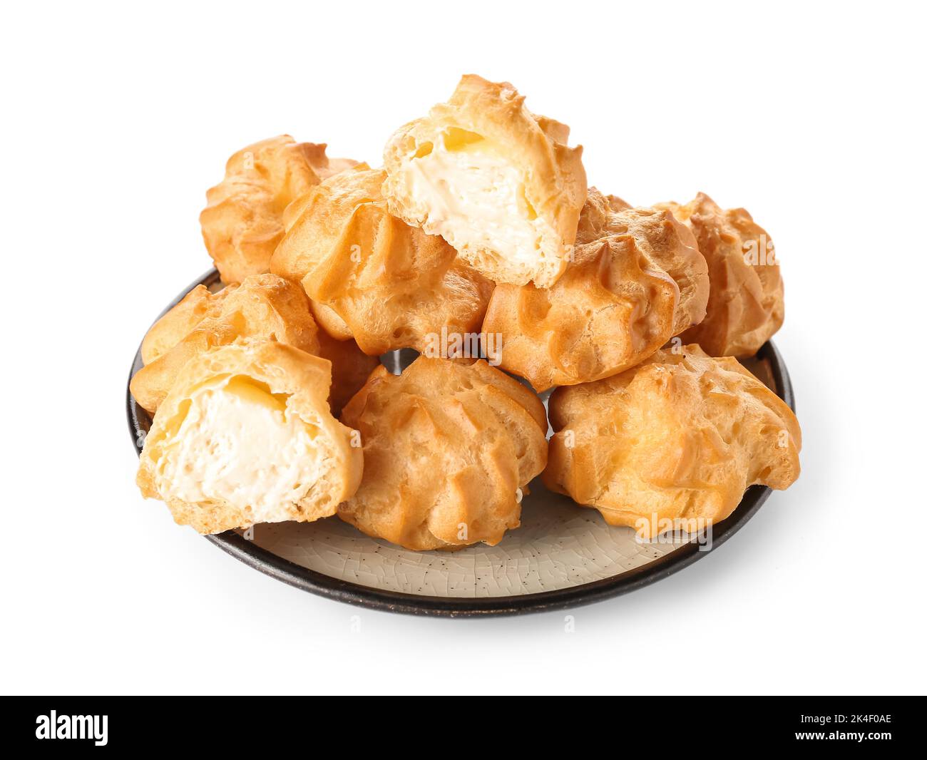 Plate with tasty round eclairs on white background Stock Photo - Alamy