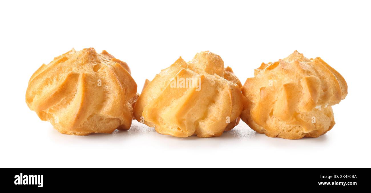 Tasty round eclairs on white background Stock Photo - Alamy