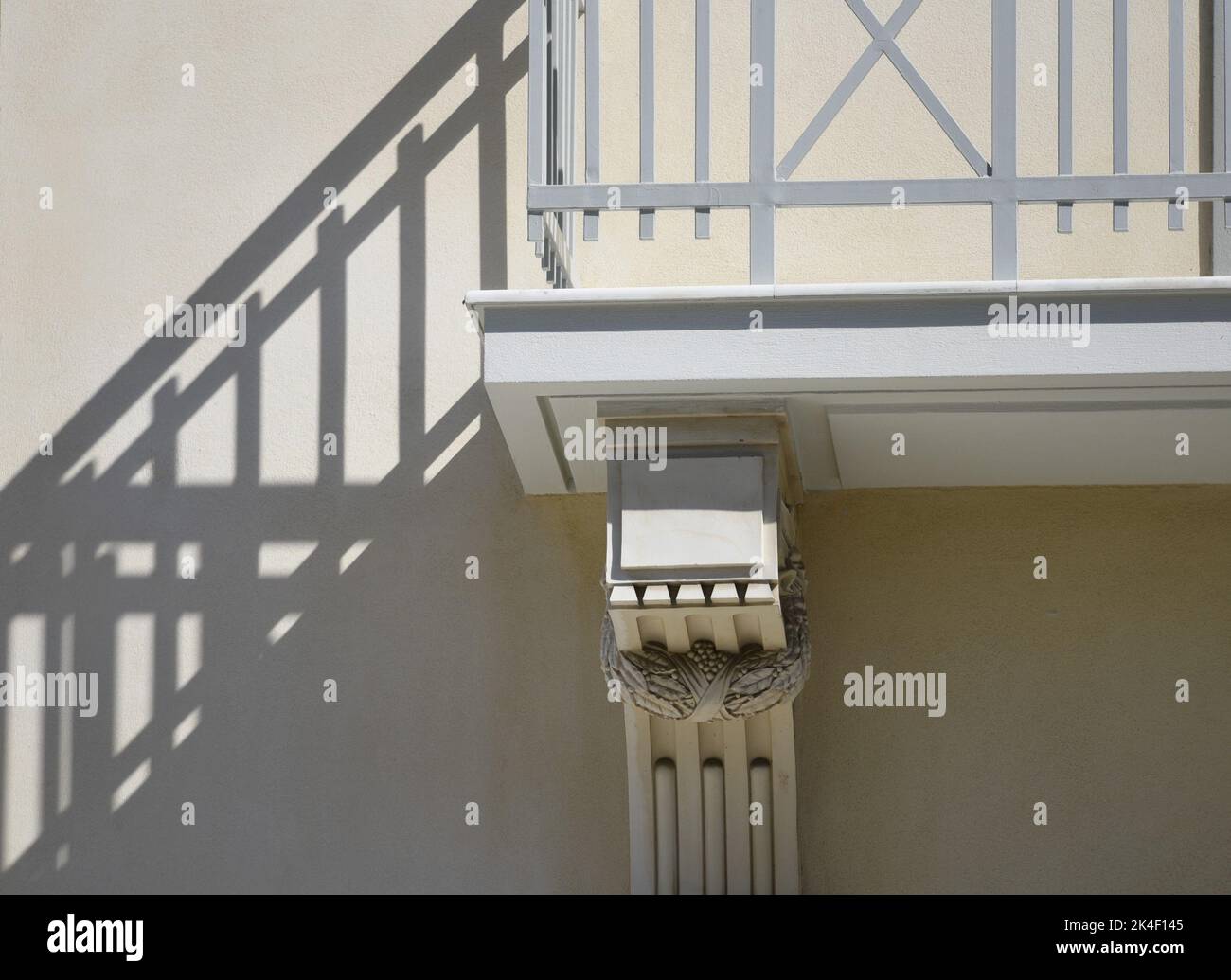 Neoclassical mansion balcony with a grey metal railing and a ...