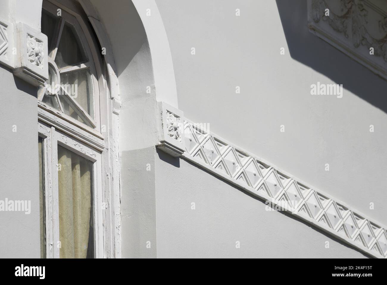 Neoclassical mansion arched wooden window on a grey stucco wall Stock ...