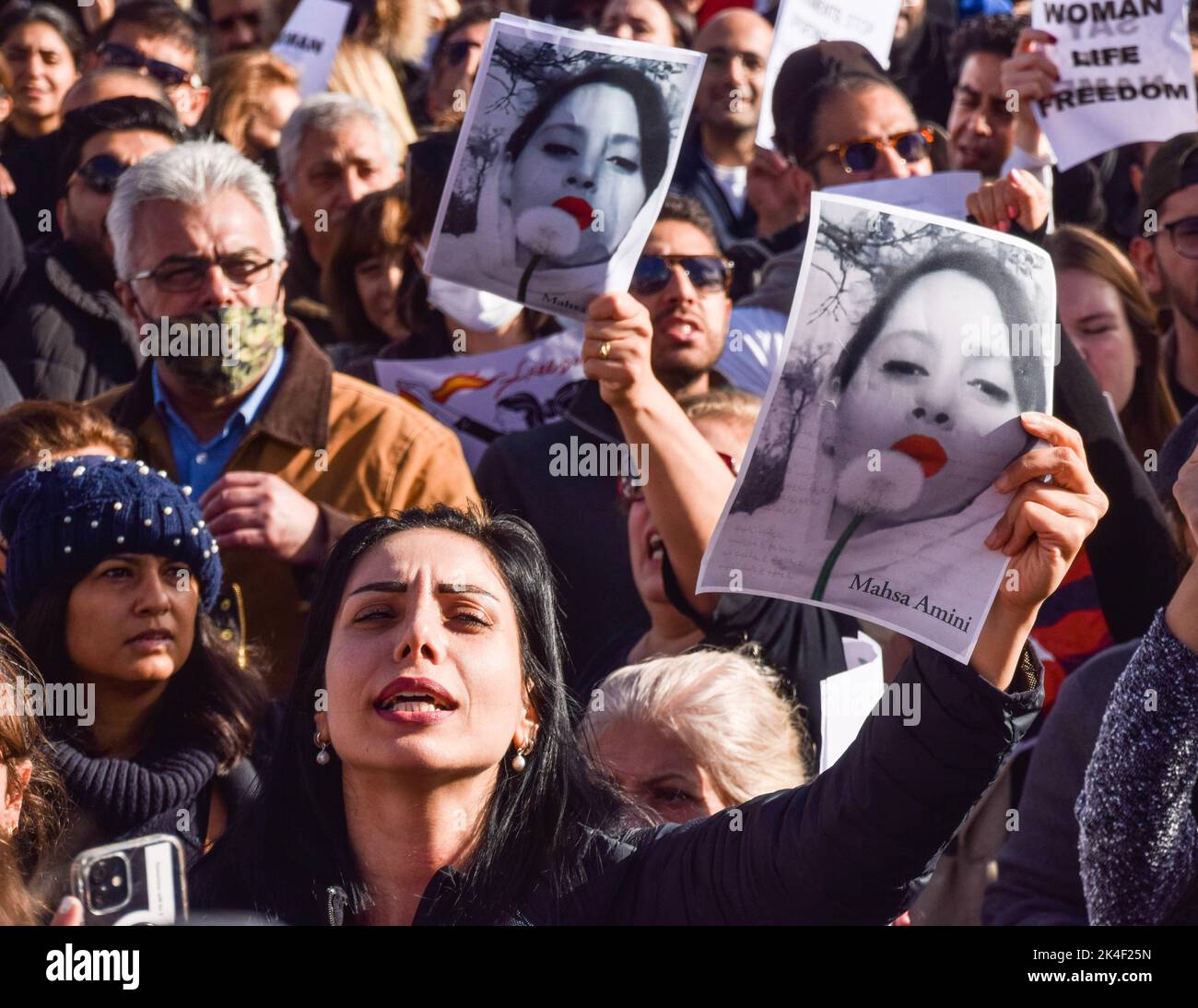 Protesters hold pictures of Mahsa Amini during the demonstration ...
