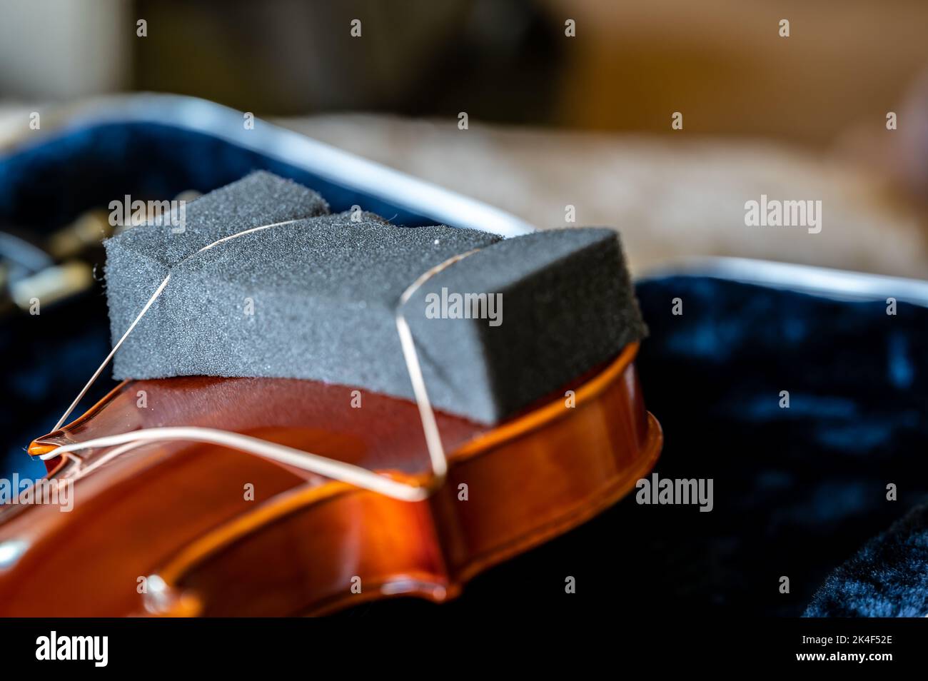 Selective focus on a foam pad being used as a shoulder rest for a youth ...