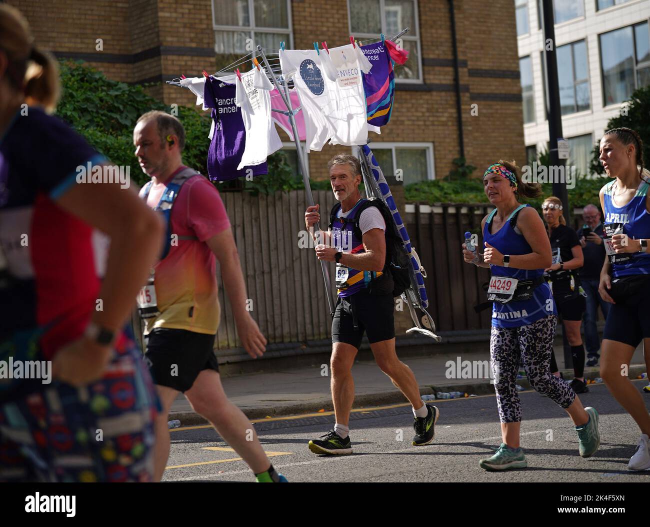A runner wearing a clothes line and ironing board during the TCS London ...