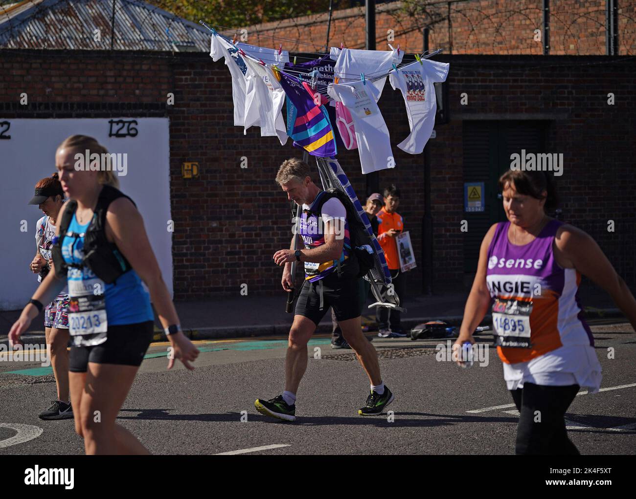 A runner wearing a clothes line and ironing board during the TCS London ...