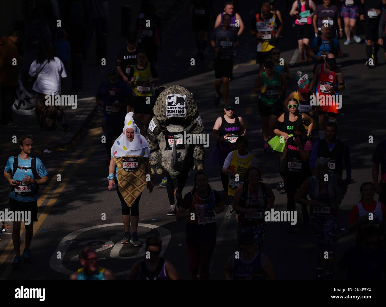 Runners wearing costumes during the TCS London Marathon. Picture date ...